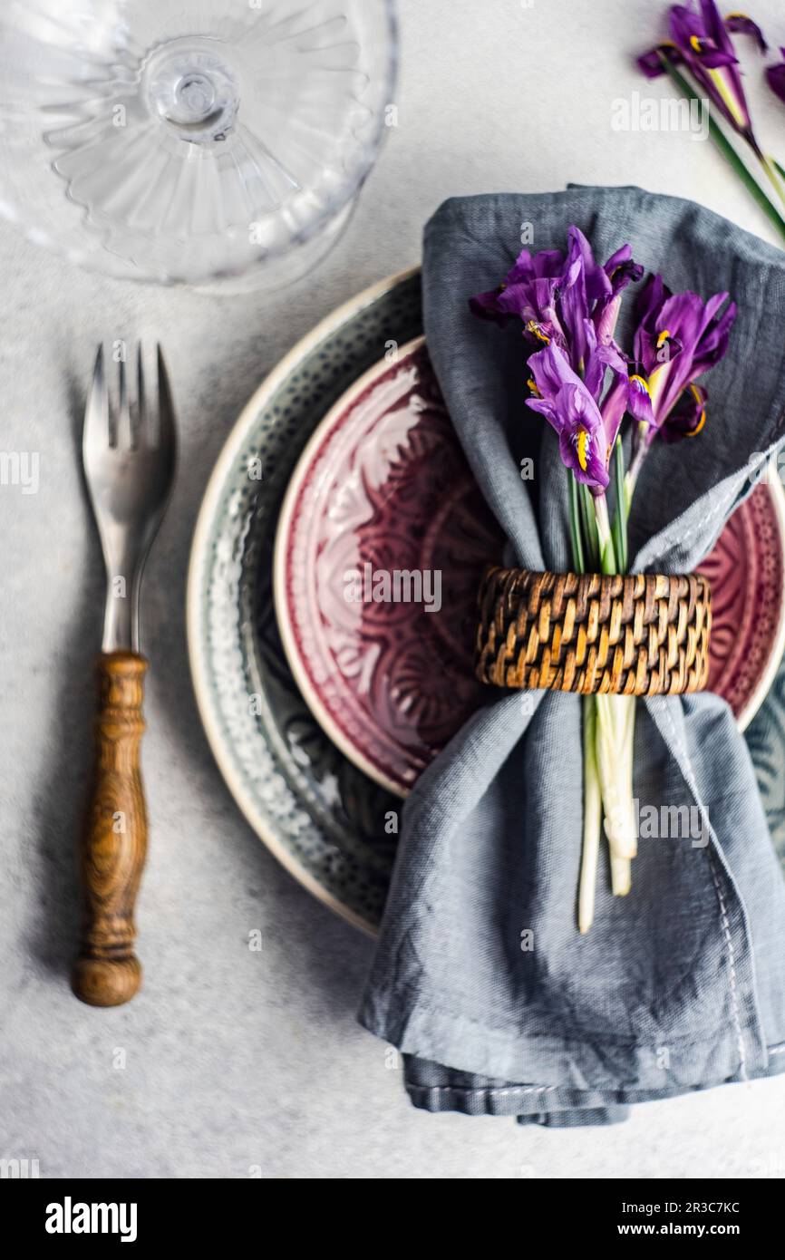 Spring floral table setting decorated with wild purple iris flowers on ...