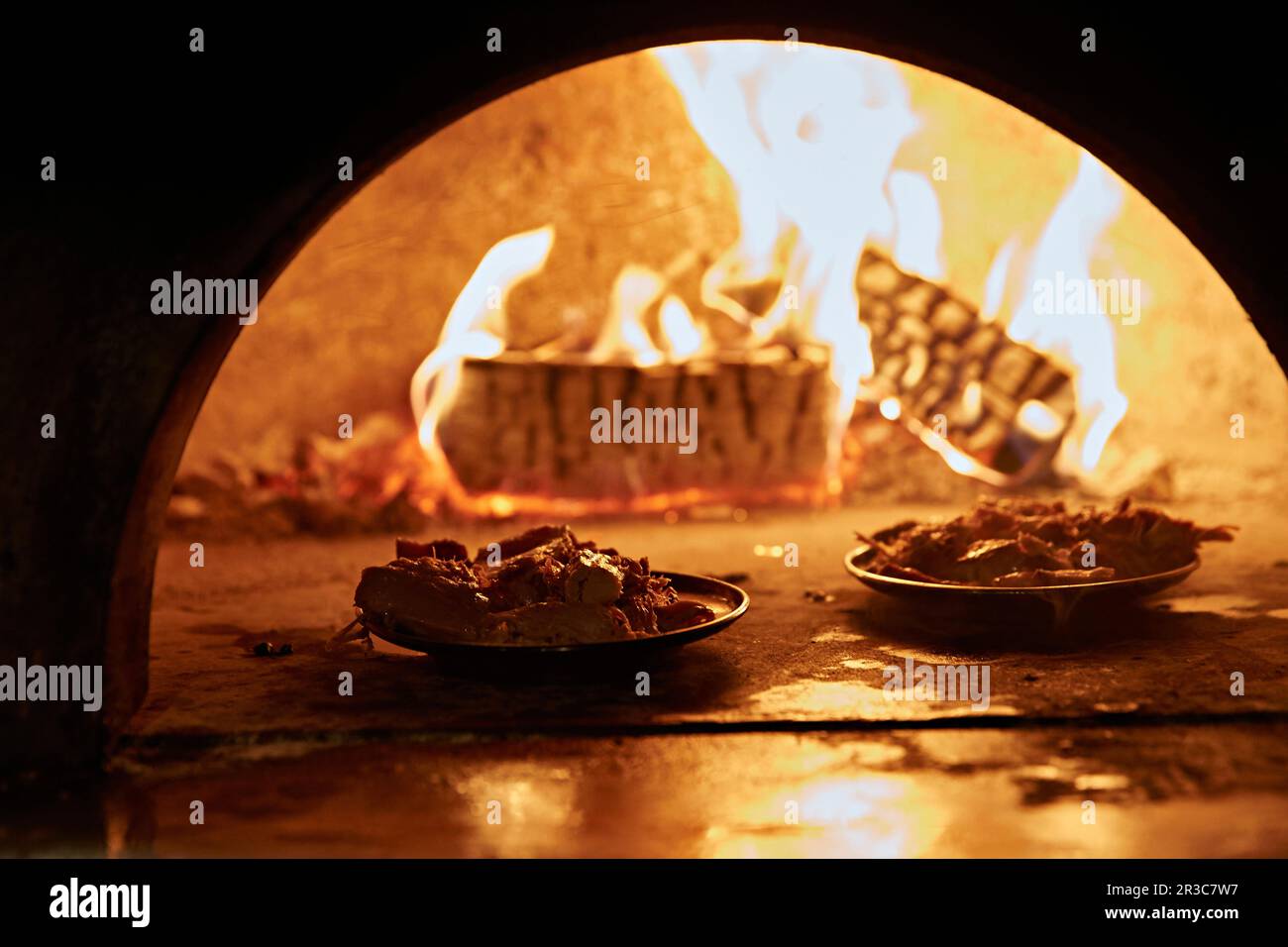 Wood fire cooking two dishes Stock Photo - Alamy