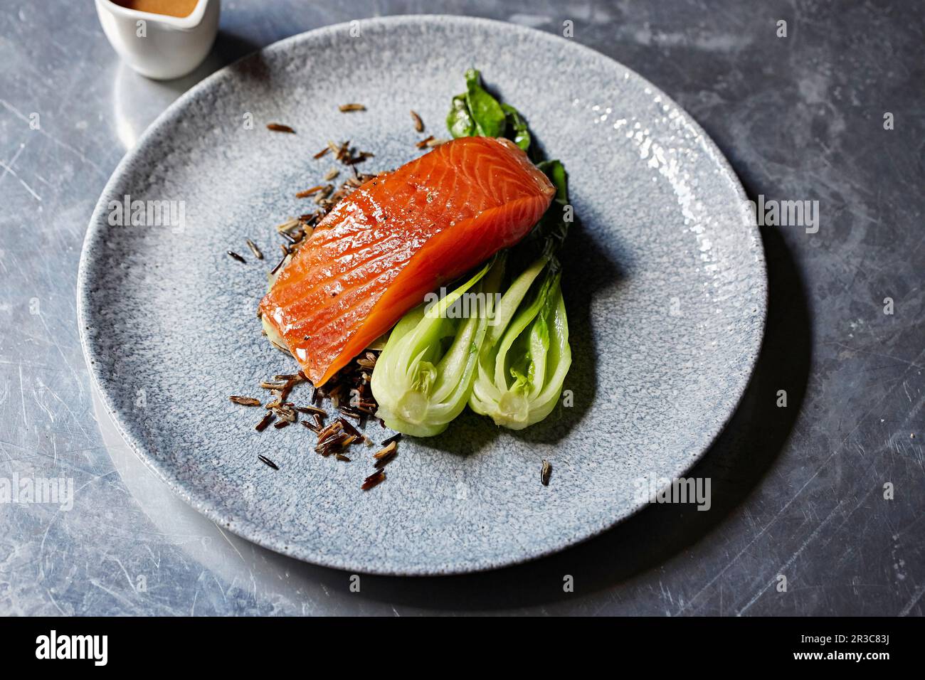 Honey-glazed salmon on pak choi and brown wild rice Stock Photo - Alamy