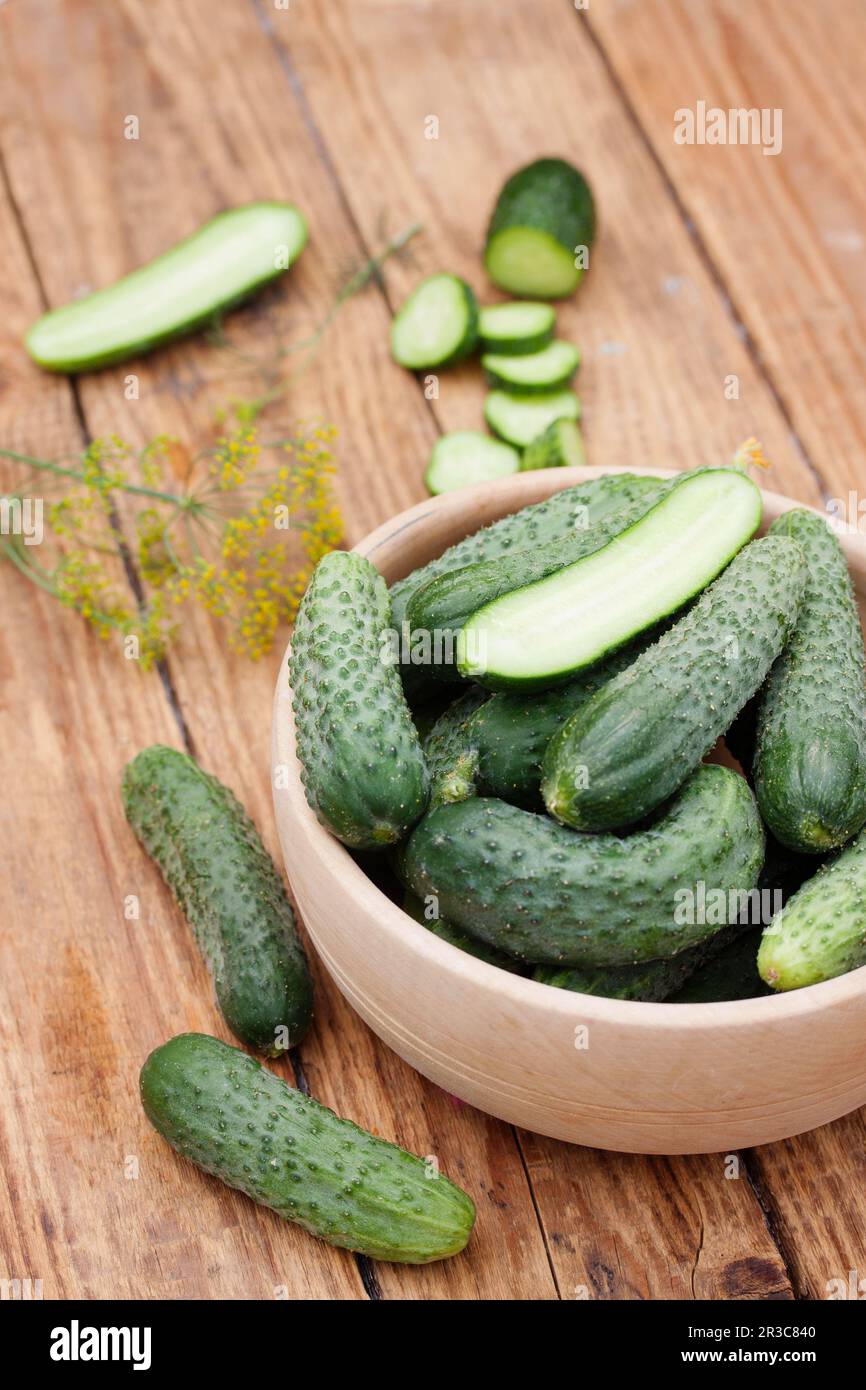 Young crunchy cucumbers in a vine basket in a rustic style Stock Photo ...
