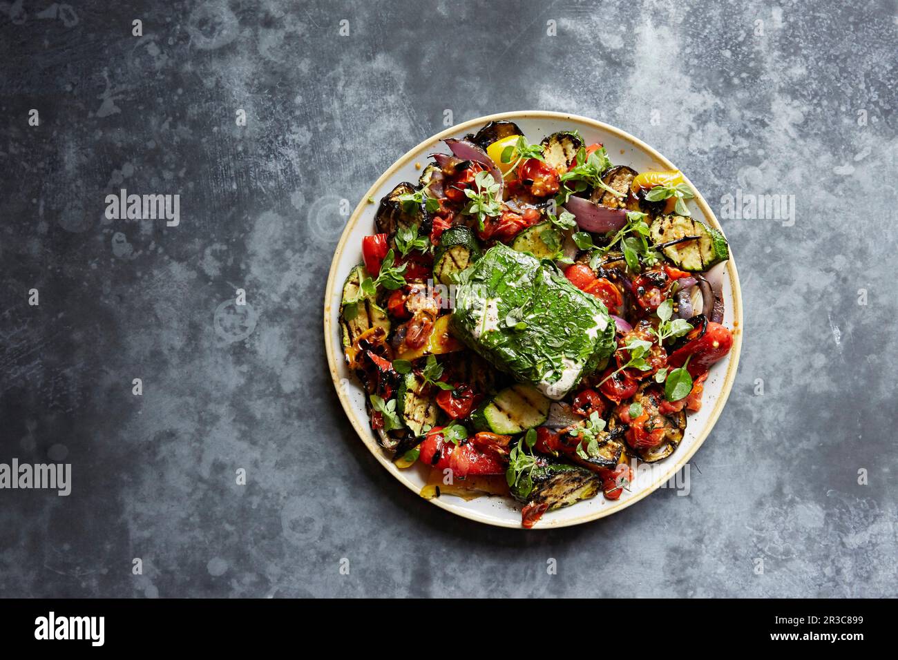 Roasted vegetables with cheese in a herb coating Stock Photo - Alamy