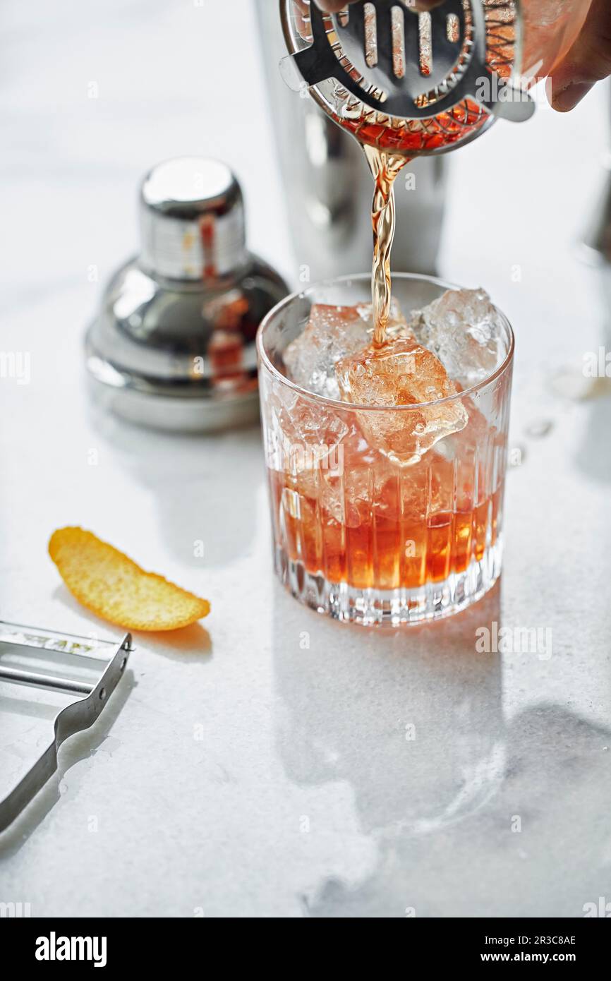 An Old Fashioned Cocktail being poured into a glass Stock Photo - Alamy