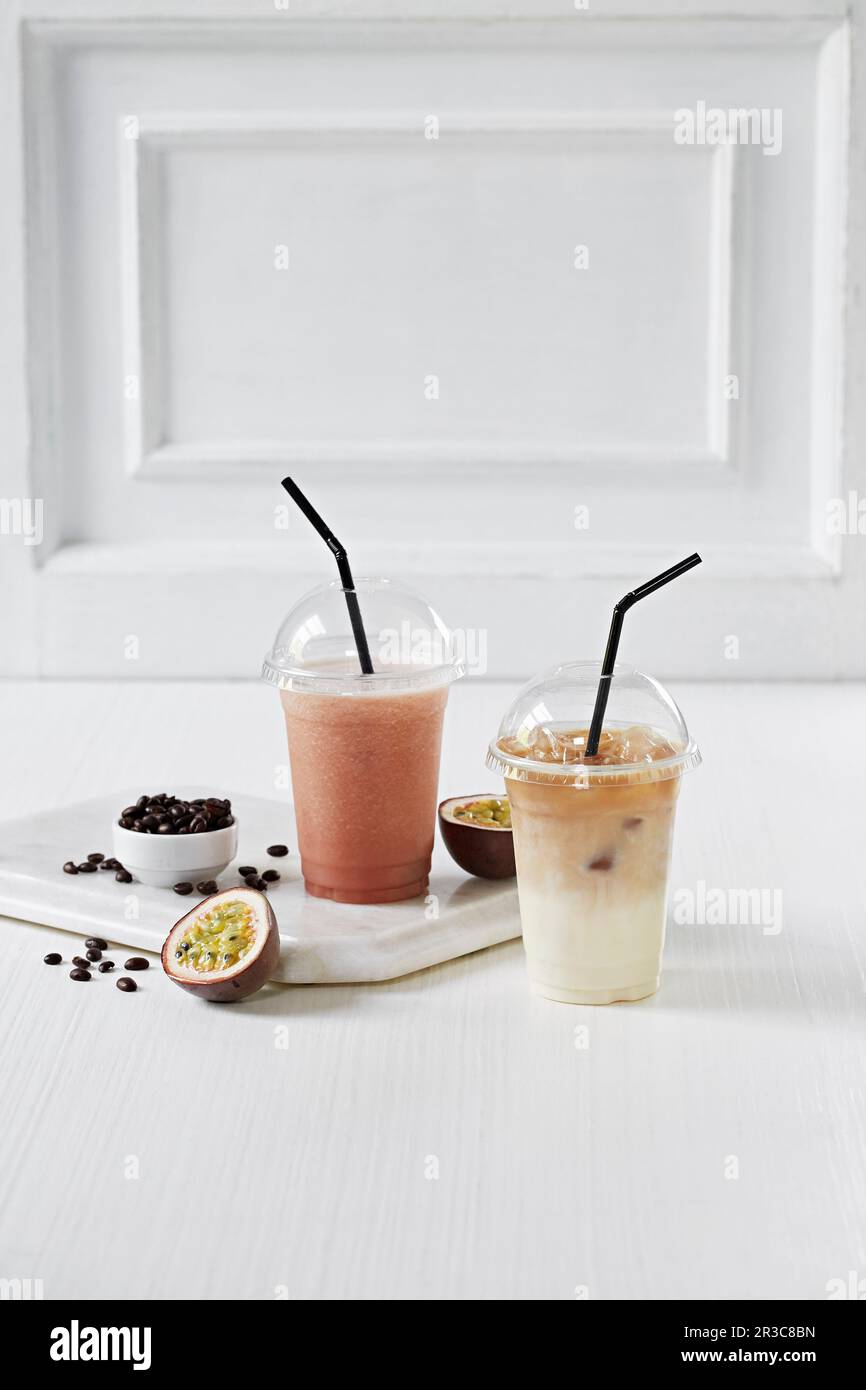 Passion fruit drink and iced coffee in take-away cups Stock Photo - Alamy