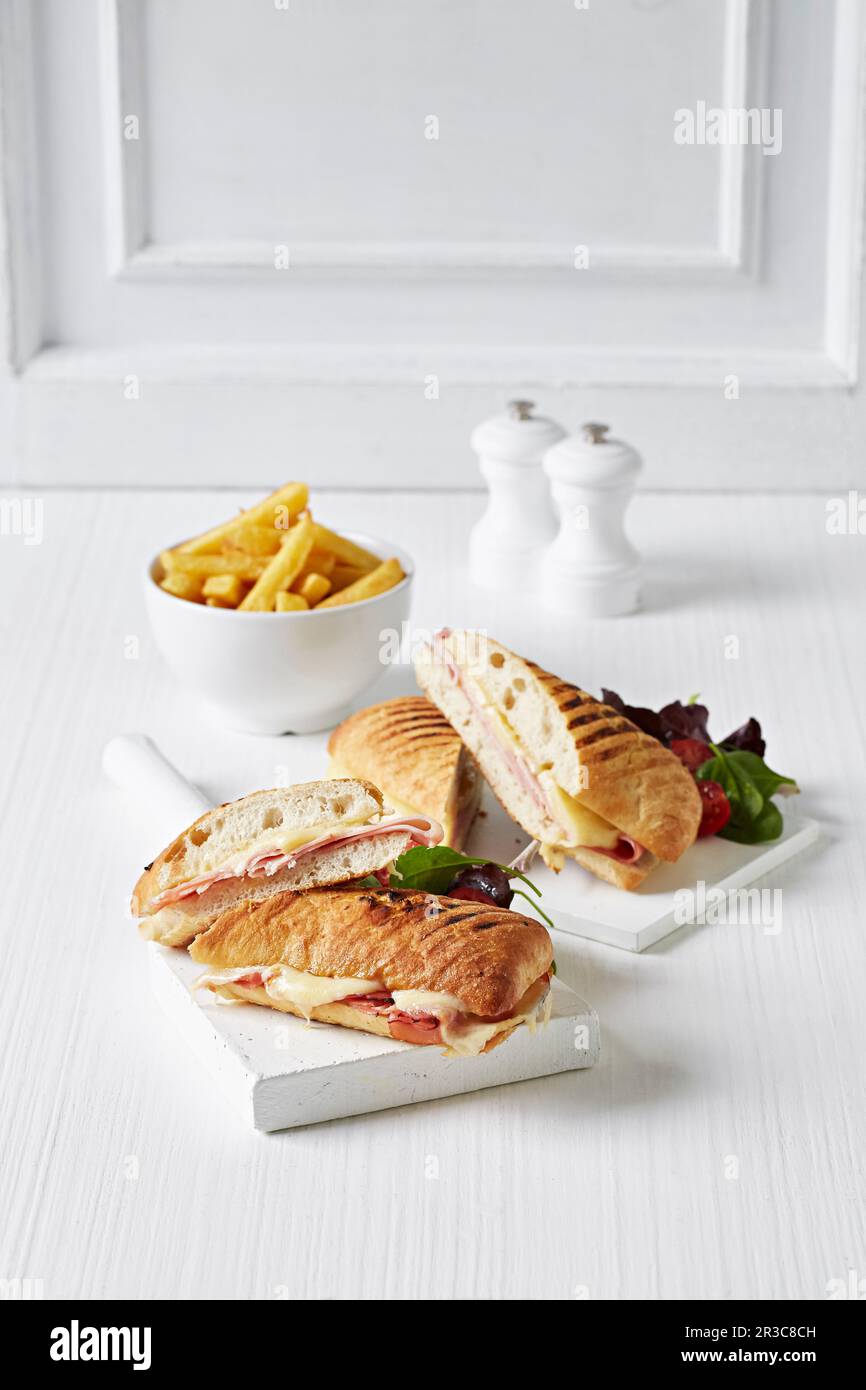 Ham and cheese panini served with French fries Stock Photo - Alamy