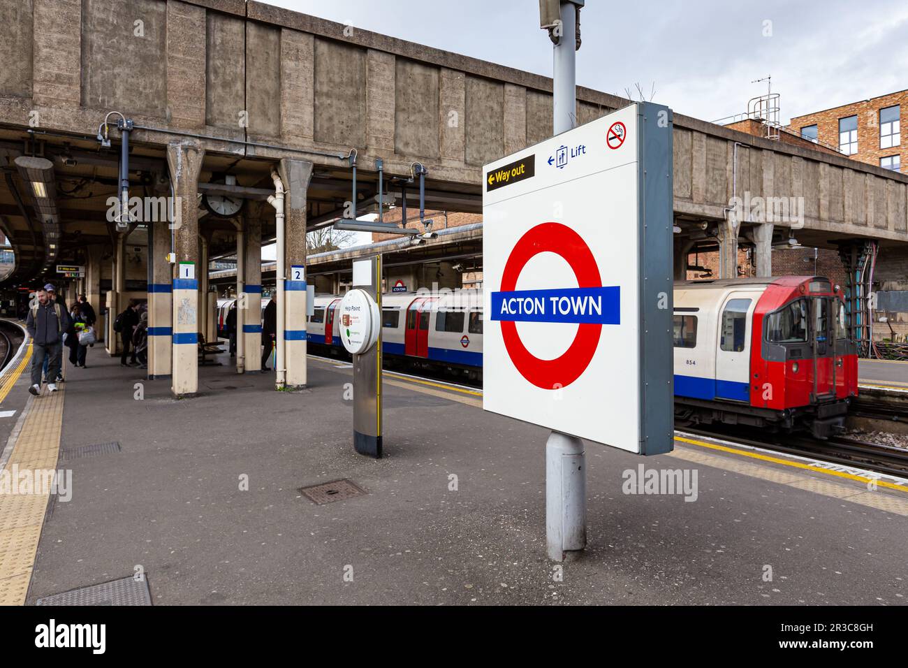 Acton Town roundel and platform with Piccadilly Line train Stock Photo ...