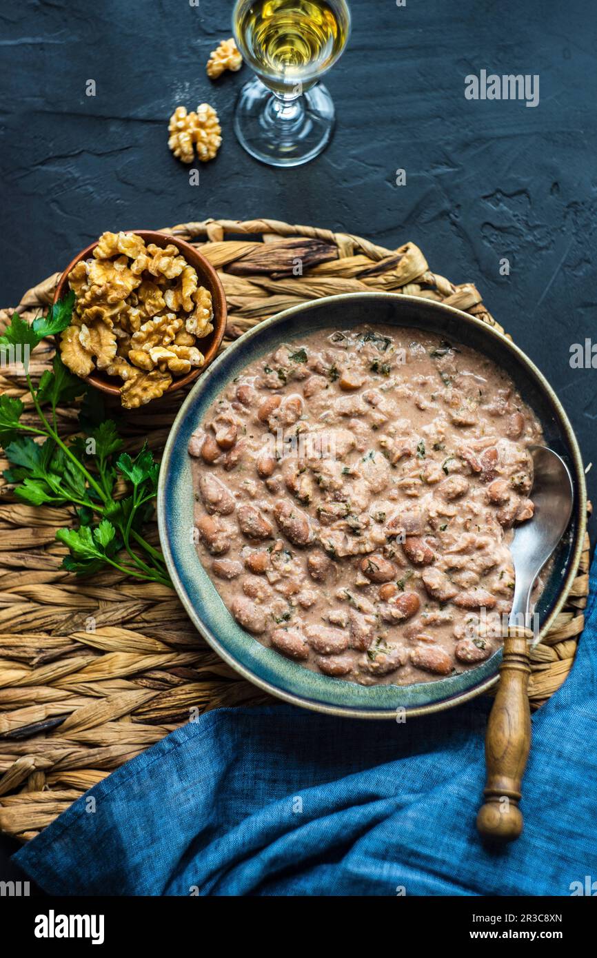 Traditional georgian lobio with walnuts served on concrete table Stock ...