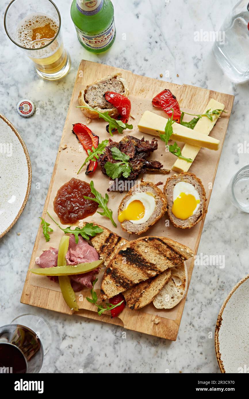 Sharing meze board and beer Stock Photo - Alamy