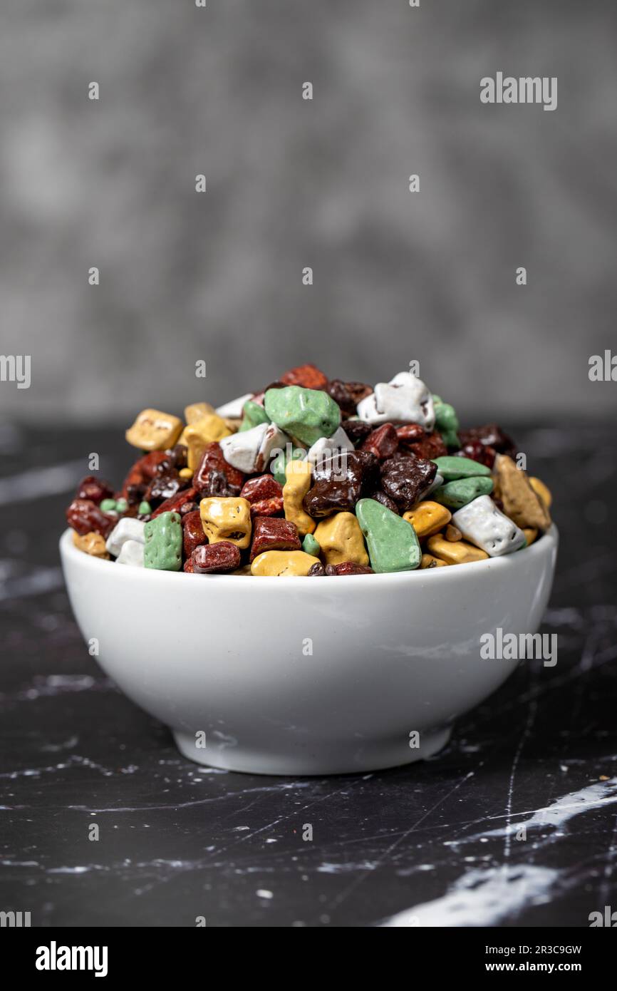 Colorful chocolate candy stones. Stone chocolate dragee in ceramic bowl ...