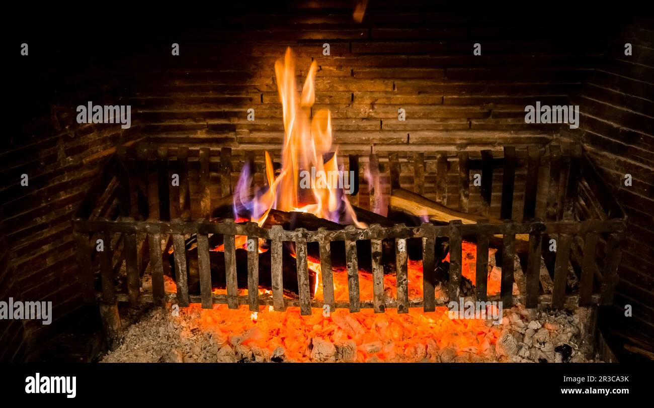 Burning logs in a Winter fireplace Stock Photo - Alamy