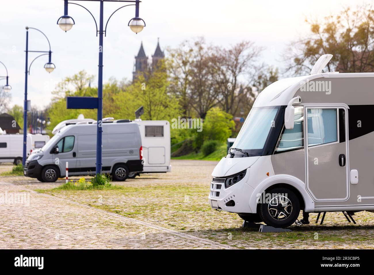 Many white modern campervan recreational motor home vehicles parked in ...