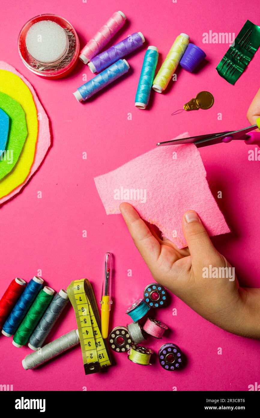 Child holding scissors and cutting out the felt Stock Photo - Alamy