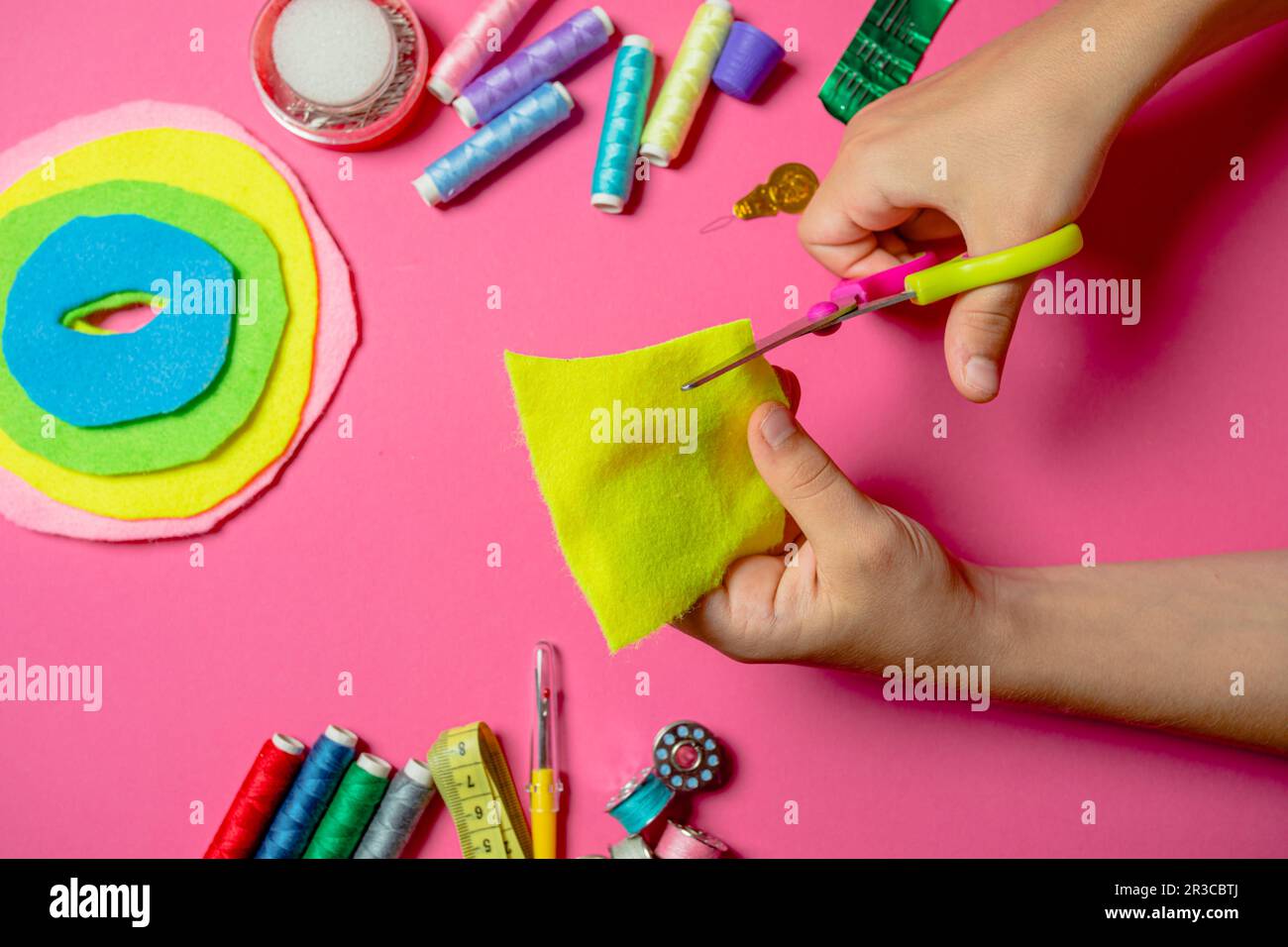 Kid creating toys from felt at home Stock Photo - Alamy