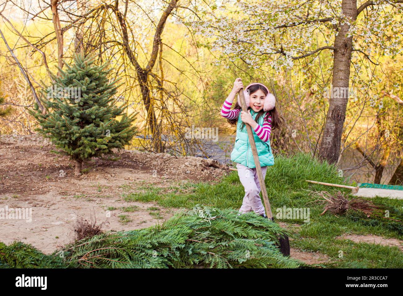 Cute girl waiting to start garden work Stock Photo - Alamy