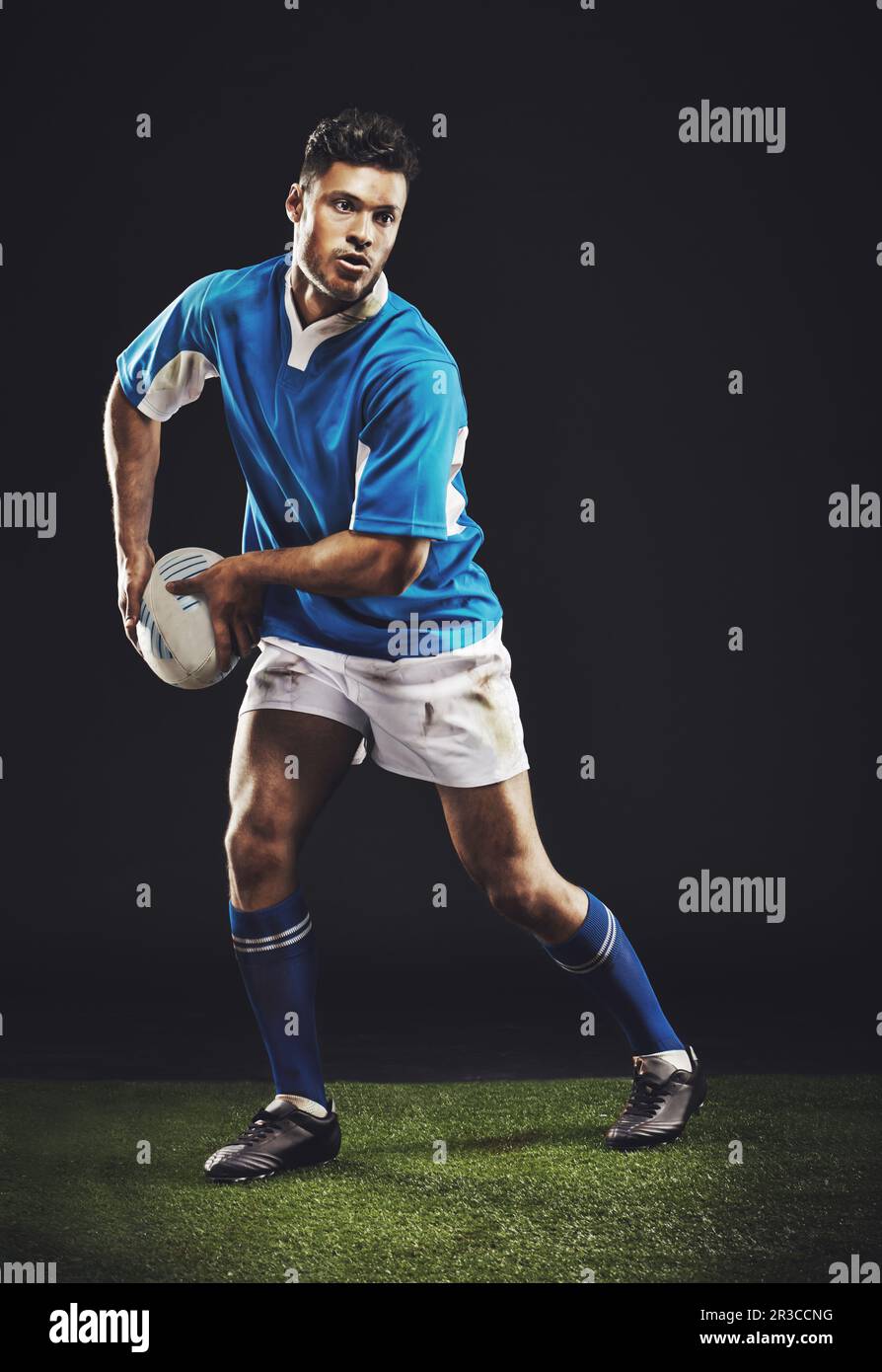 Rugby, passing and man athlete running in dark studio background while ...
