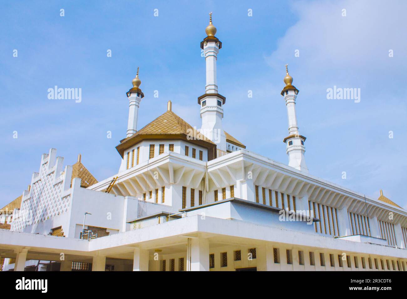 Grand white mosque with golden domes, blue sky background, Tasikmalaya ...