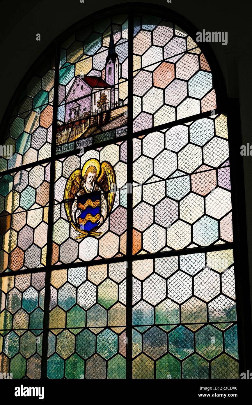 A beautifully crafted window with colored glass pieces held together by ...