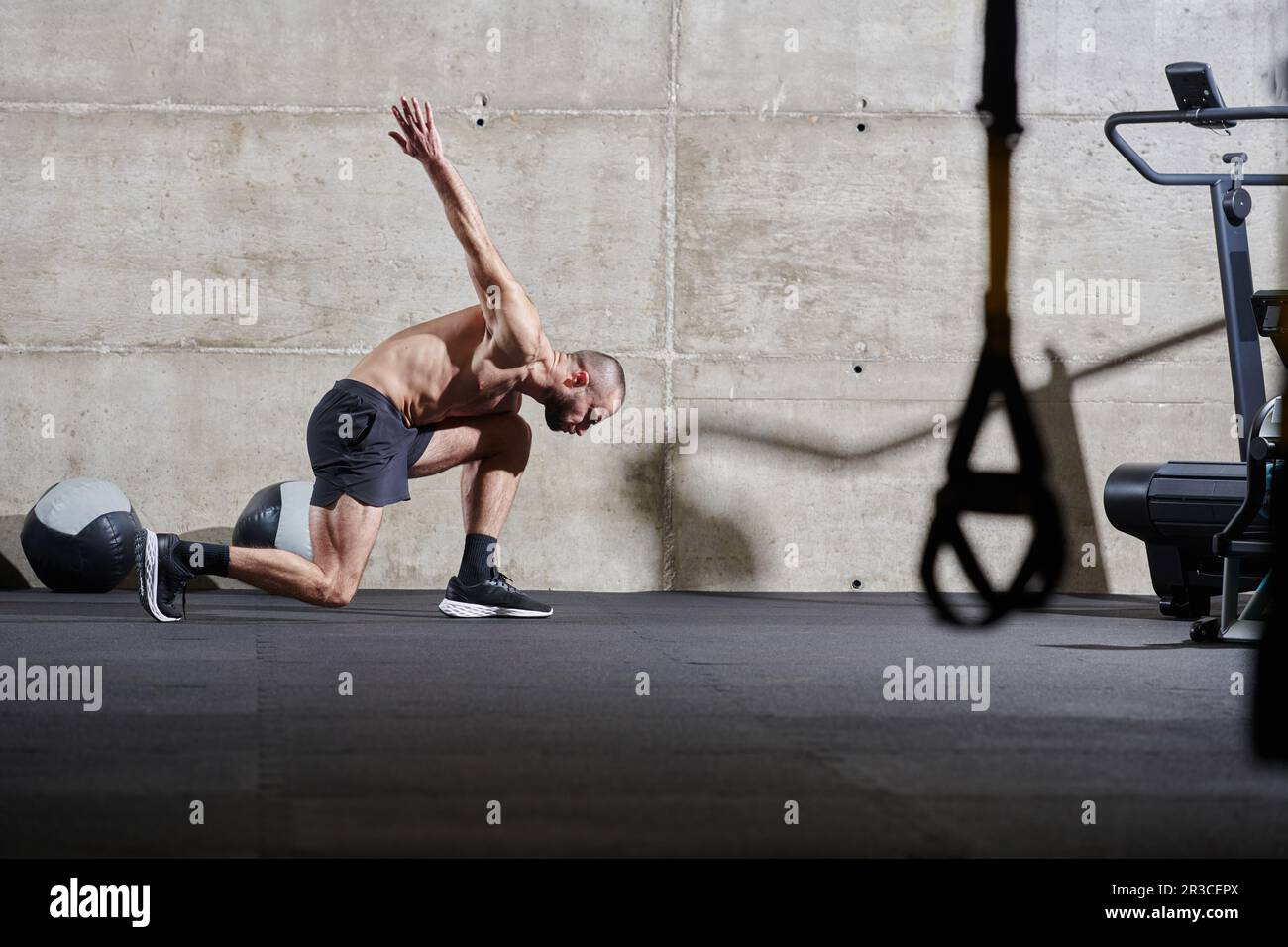 A muscular man standing in the starting position for running, exuding ...