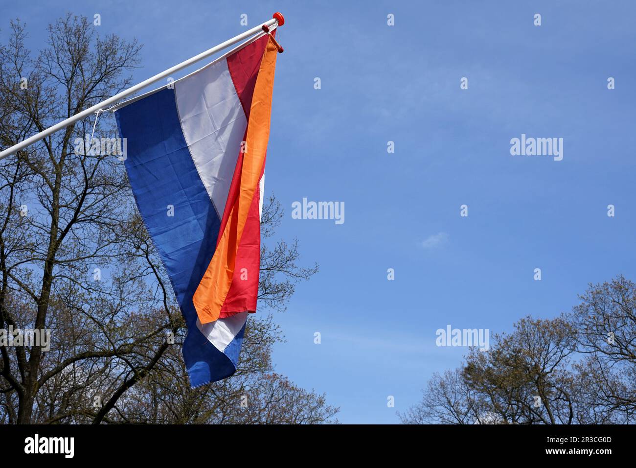Dutch flag in red, white and blue, with orange pennon behind the flag ...