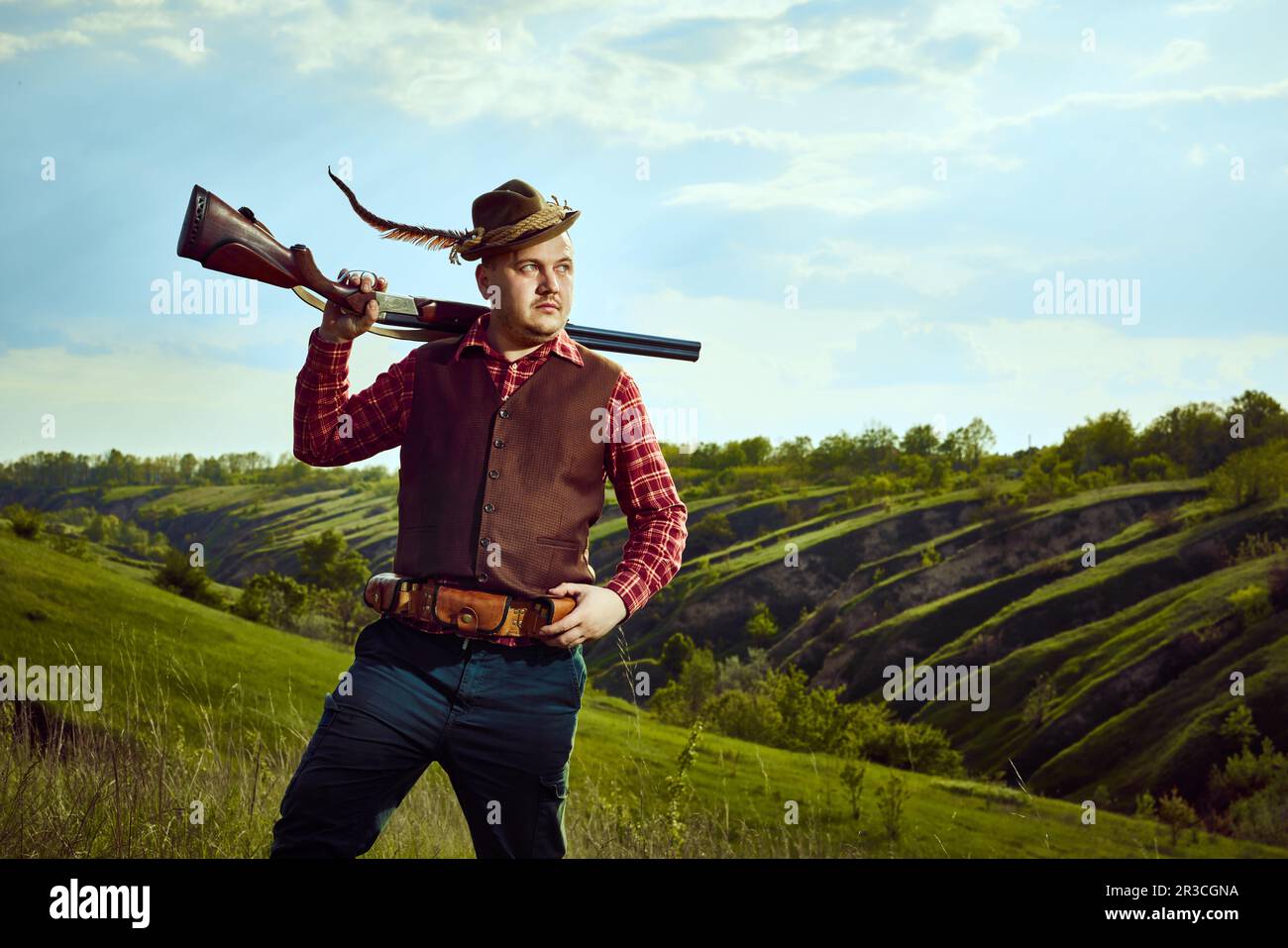 Portrait with pensive man, hunter wearing vintage hat with feather ...