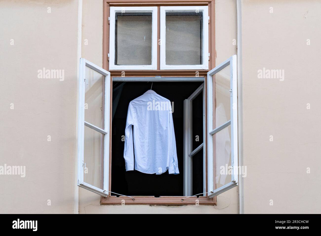 Shirt drying in an open window Stock Photo - Alamy