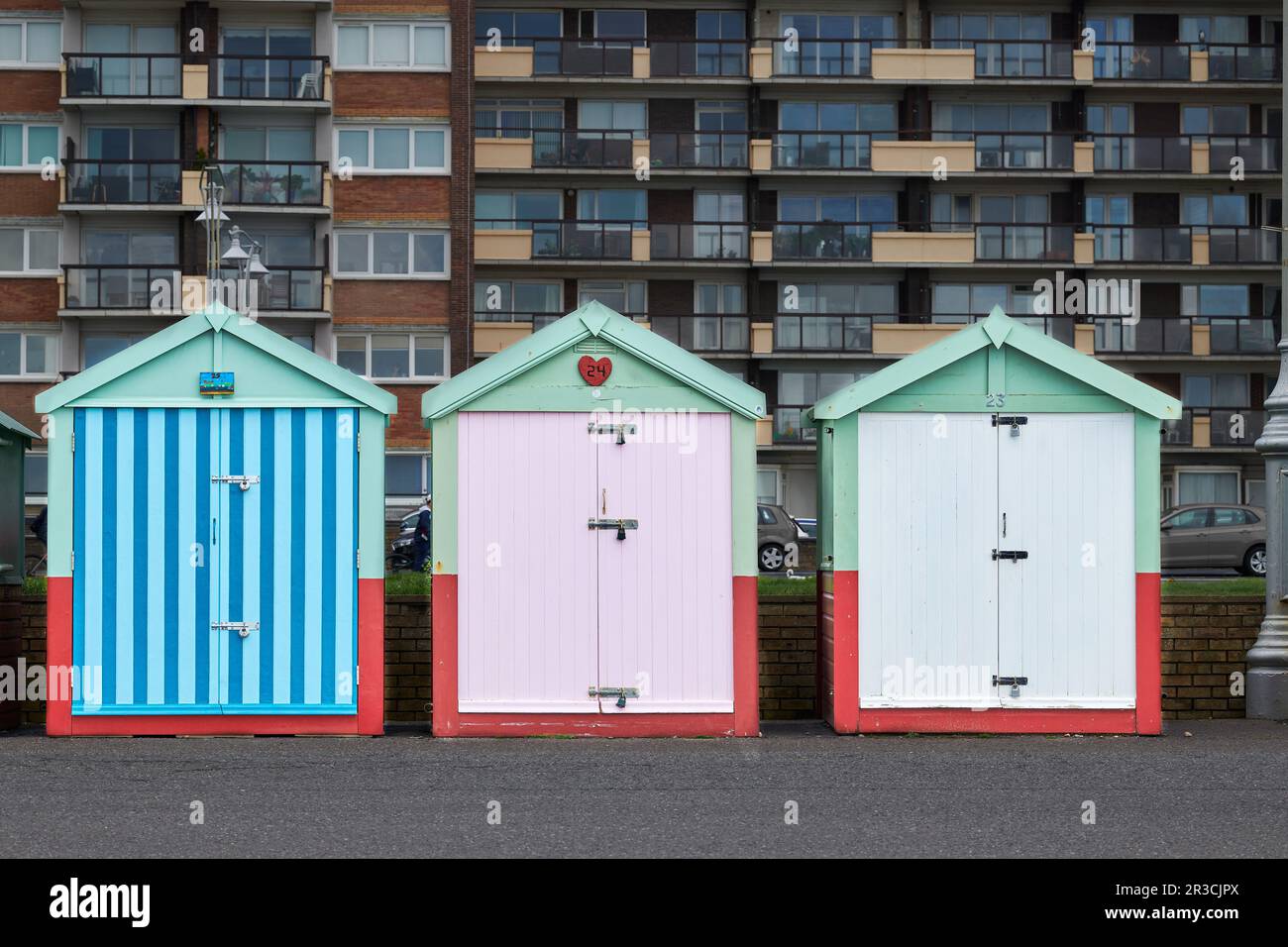 A trio of colorful painted bathing huts on the promenade of Brighton ...