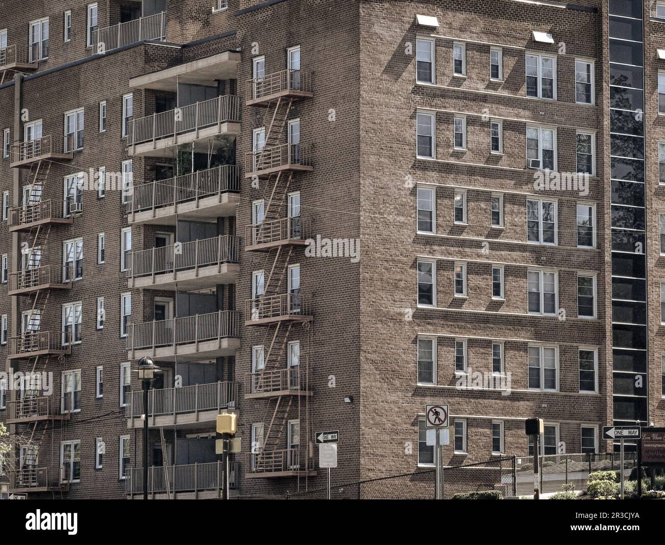 Massive brick apartment building with fire escape Stock Photo - Alamy