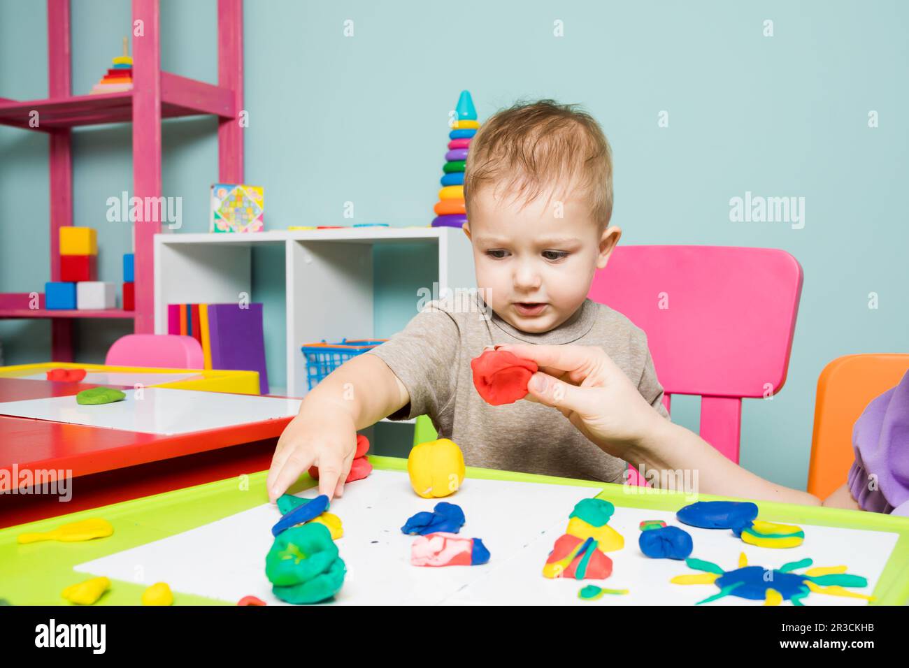 The baby boy develops creativity in the children's center Stock Photo ...