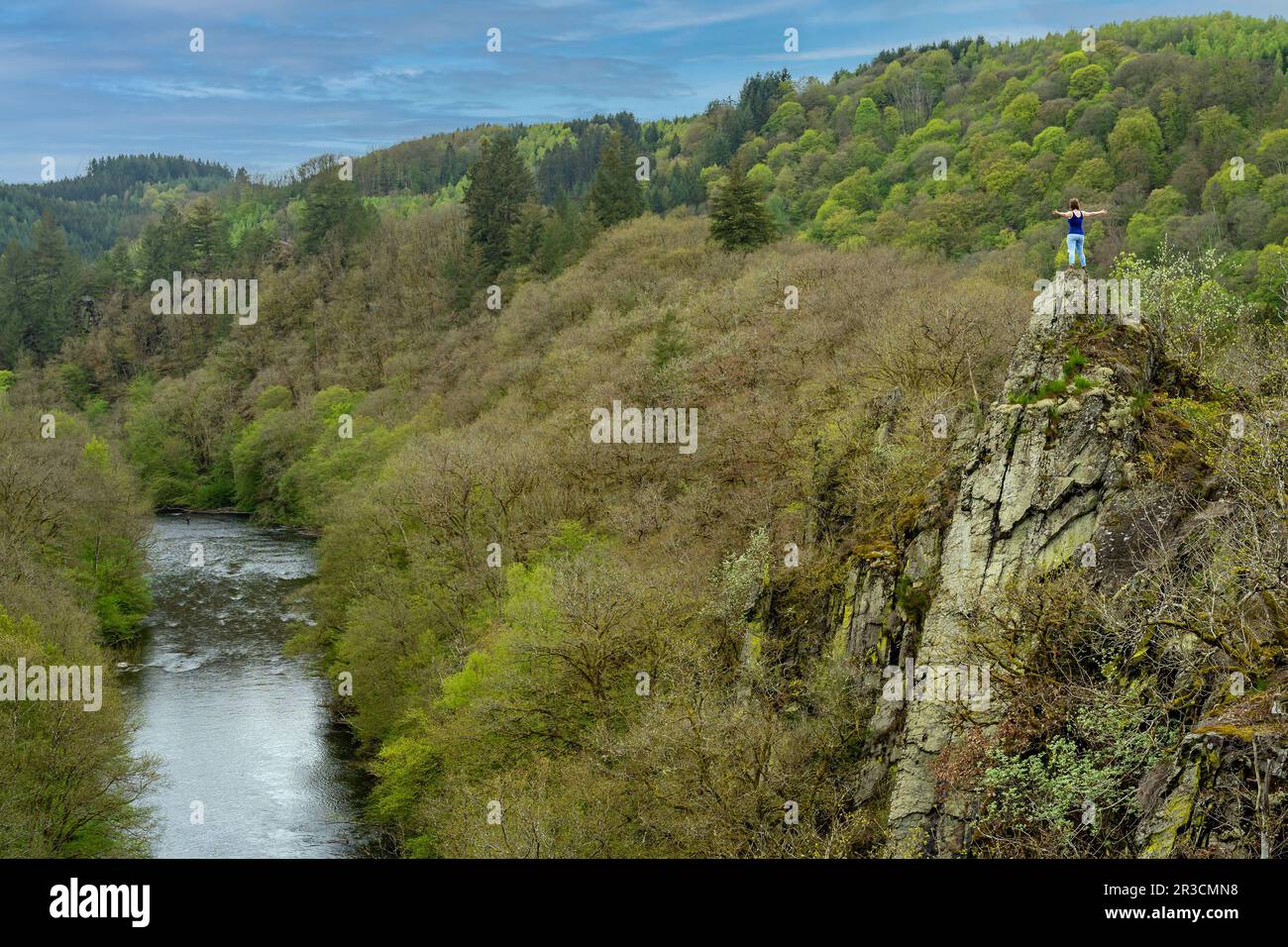 Hiker standing on the rock formation in the natural park Le Herou in ...