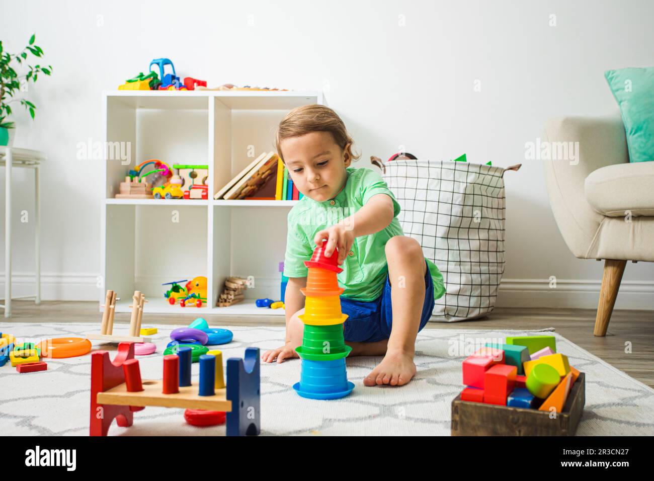 Child having good time at home or daycare Stock Photo - Alamy
