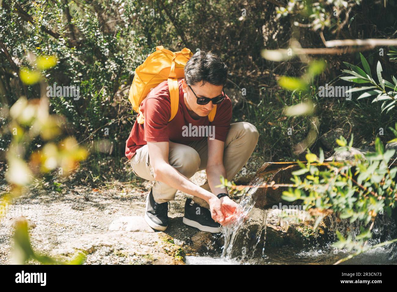 Man drinking from natural spring hi-res stock photography and images ...