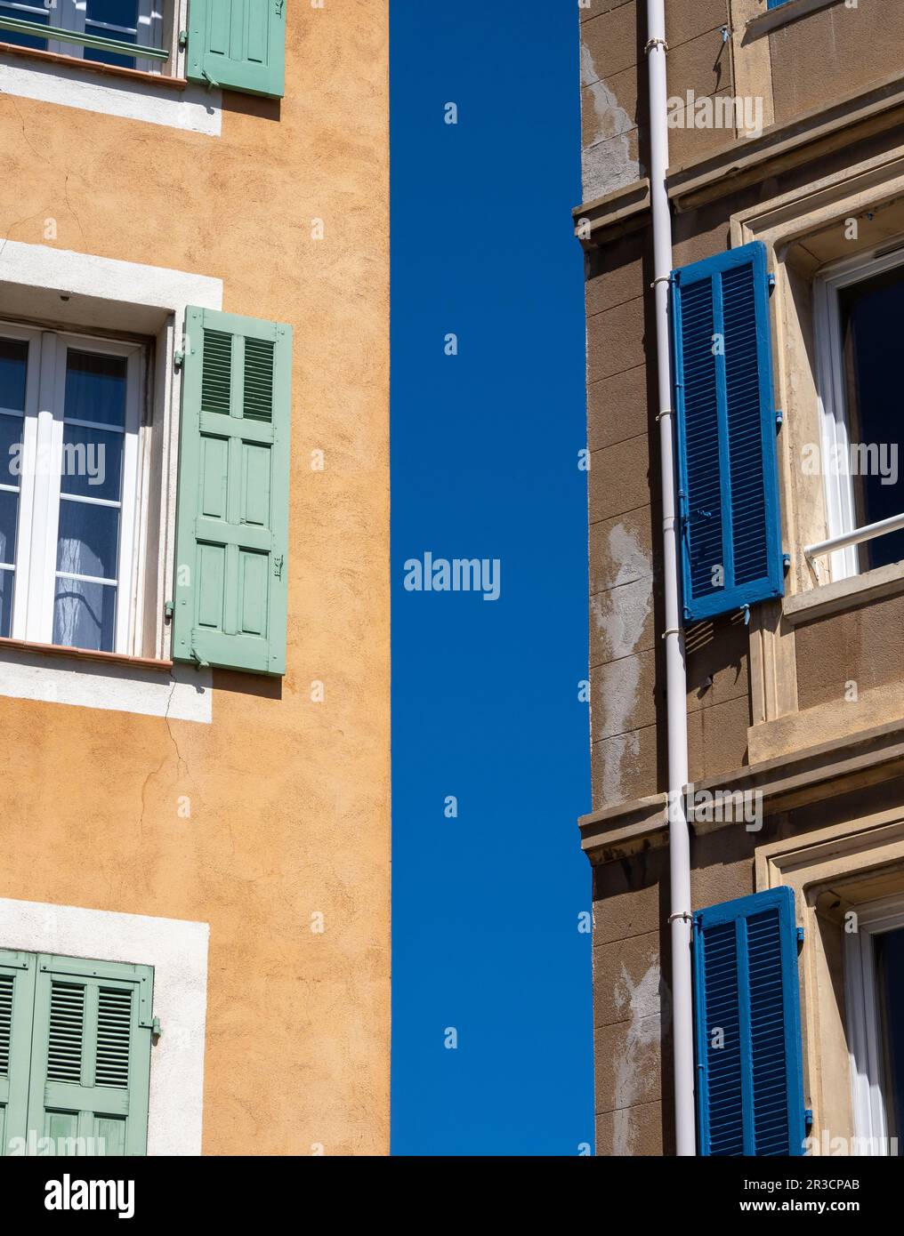Blue Sky inbetween Houses Stock Photo - Alamy