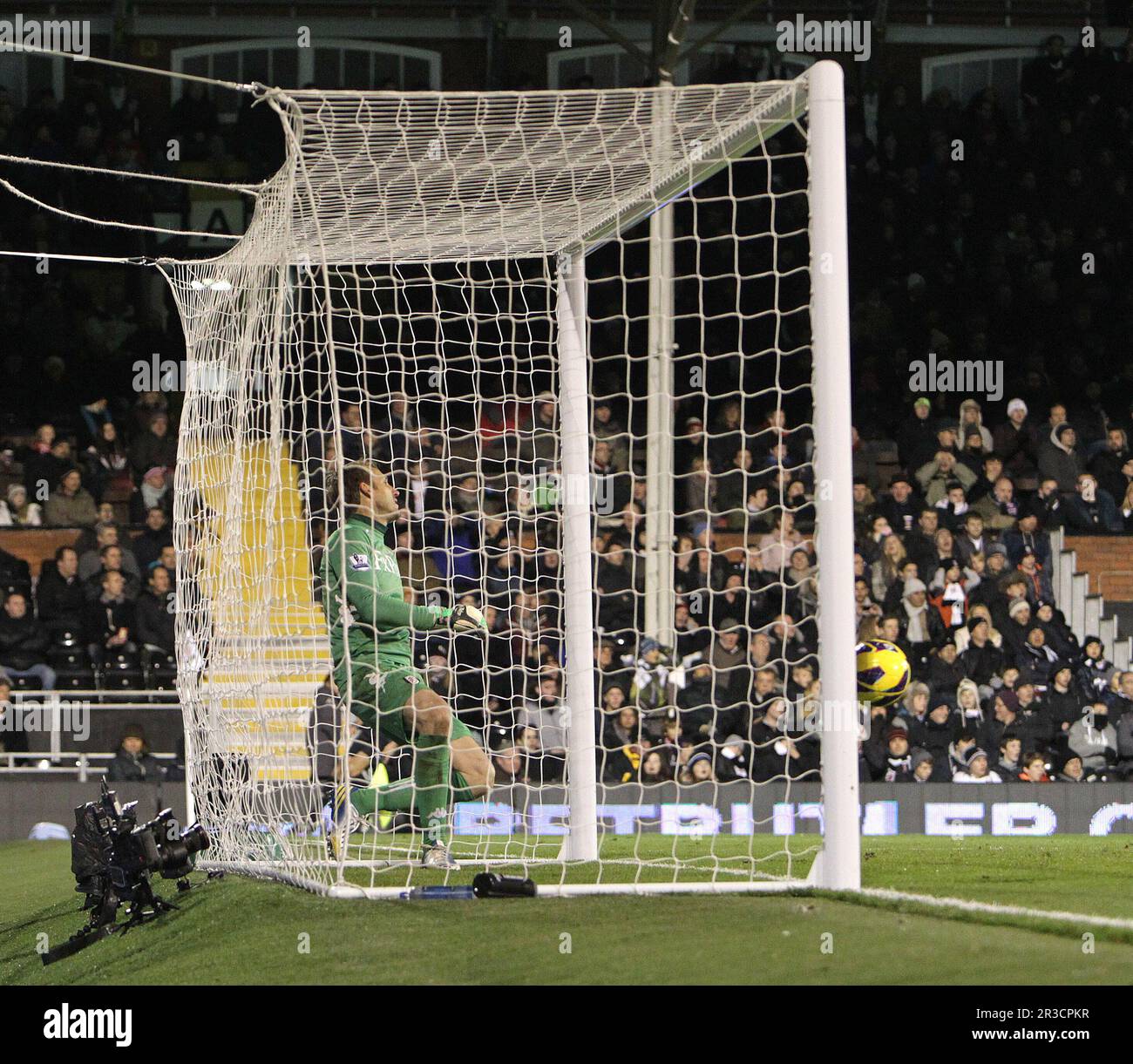 Fulham's Mark Schwarzer makes an error and miss judges the cross from ...
