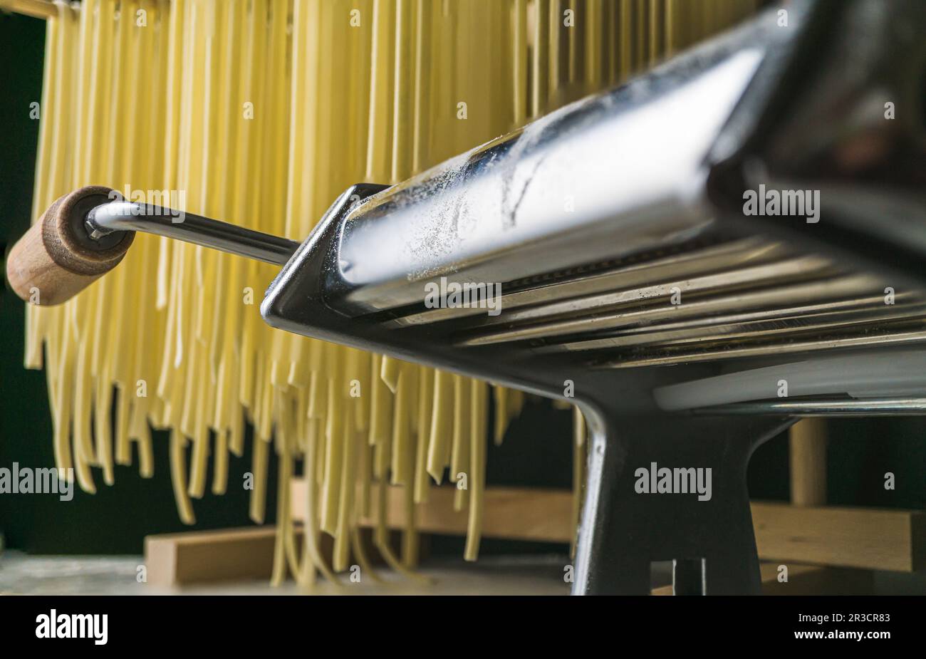 Fresh fettuccine drying on a wooden rack. Close up Stock Photo - Alamy