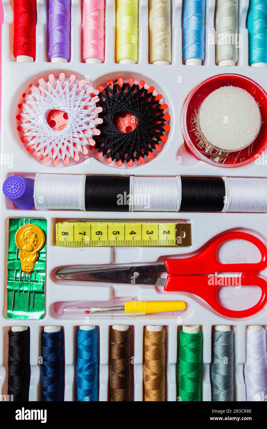 Set of sewing tools in white box Stock Photo - Alamy