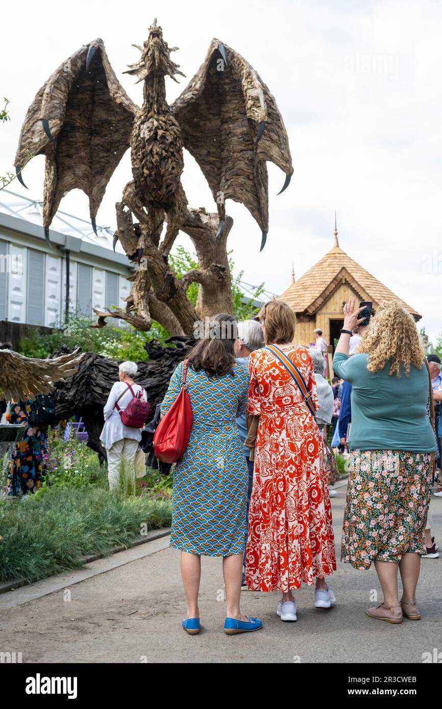 London, UK. 23 May 2023. Women look at a dragon sculpture at the ...