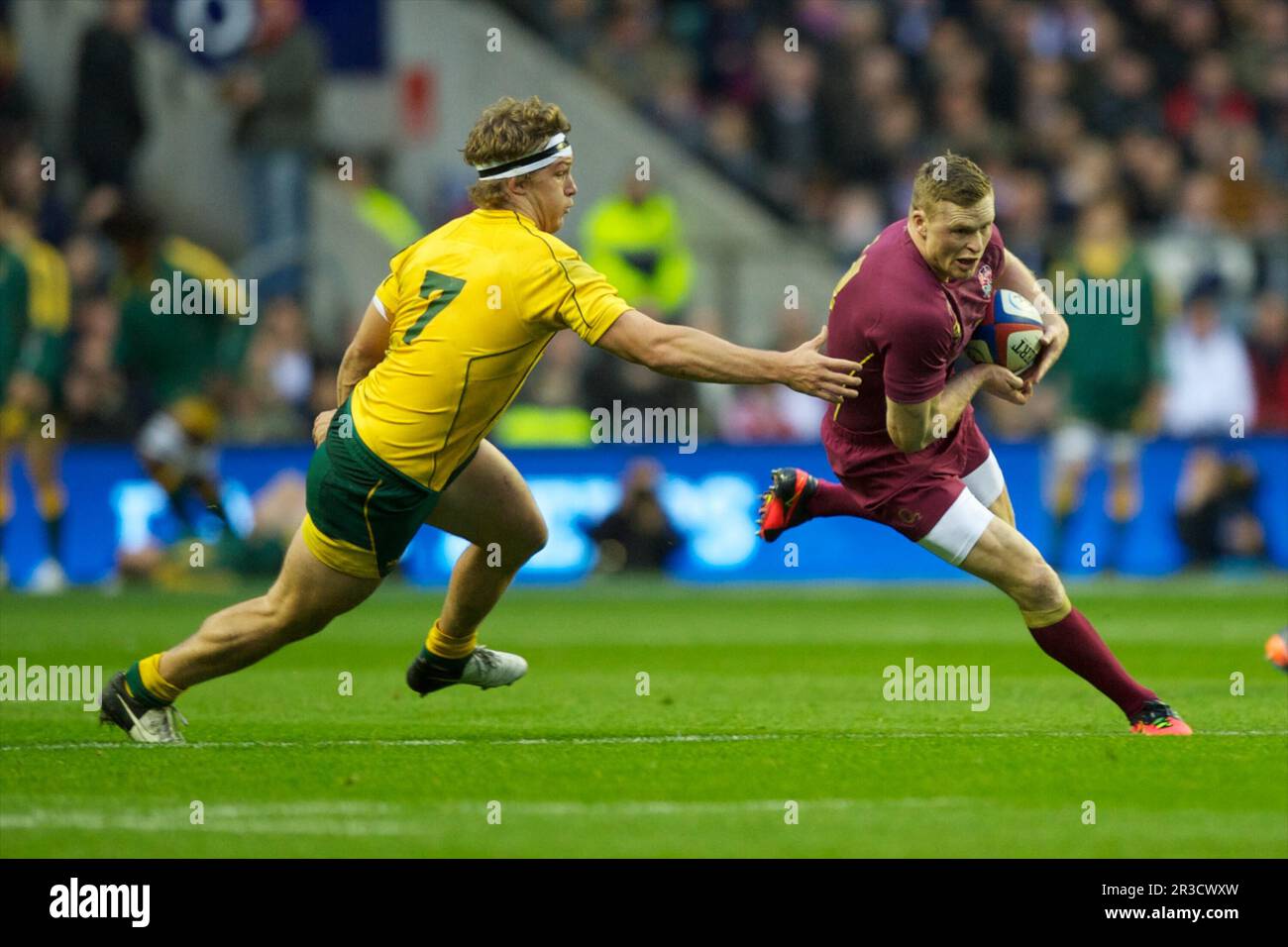 Chris Ashton of England goes round Michael Hooper of Australia during ...