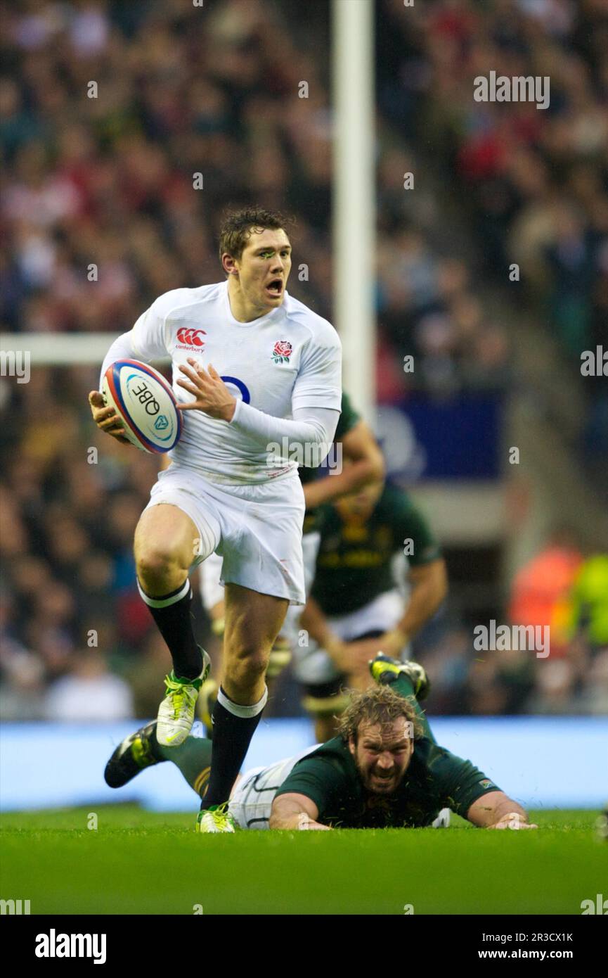 Alex Goode of England launches an attack after evading the tackle of ...