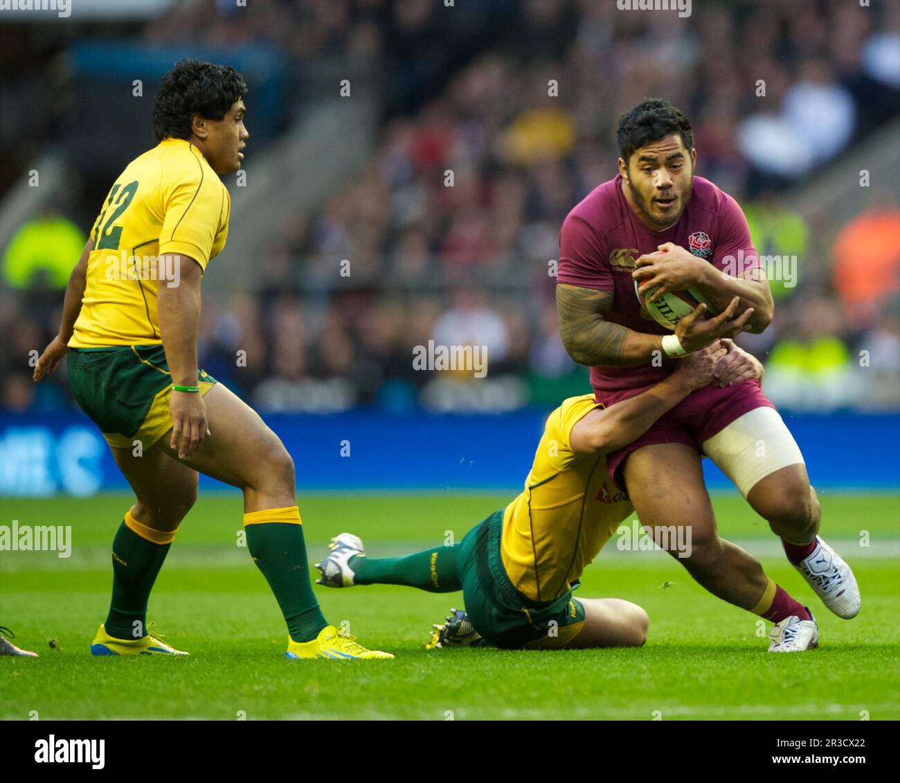 Manu Tuilagi of England is tackled by Nick Phipps of Australia during ...
