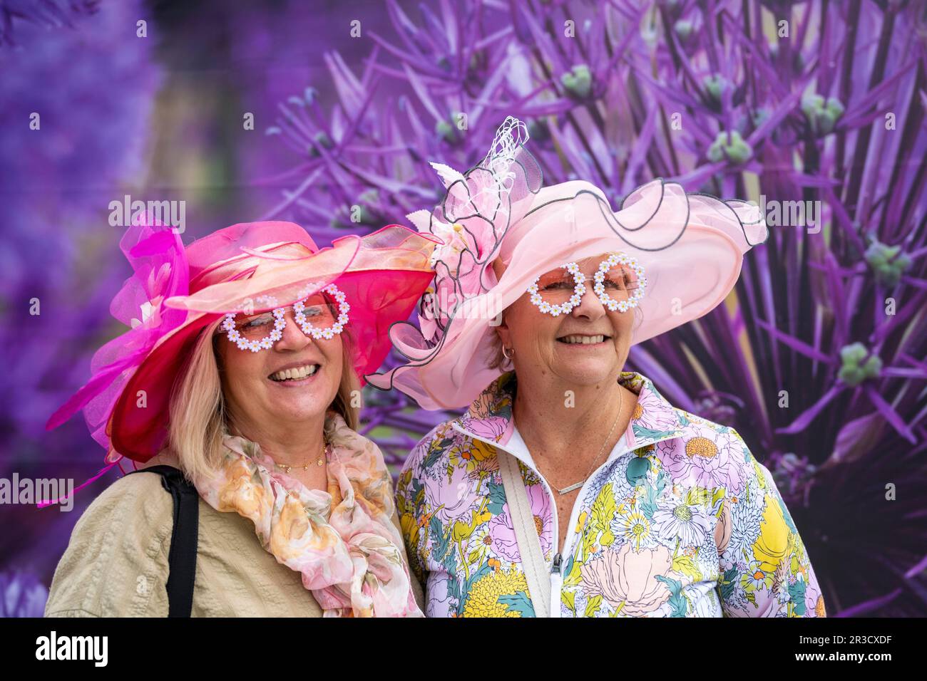 London, UK. 23 May 2023. Women in colourful hats and sunglasses at the ...