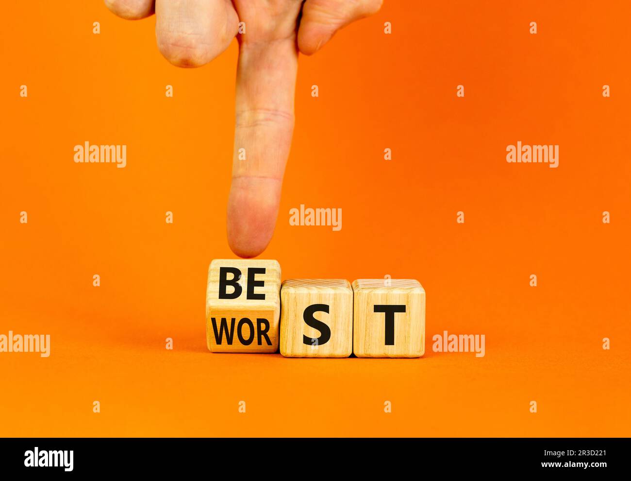 Best or worst symbol. Businessman turns wooden cubes and changes the ...