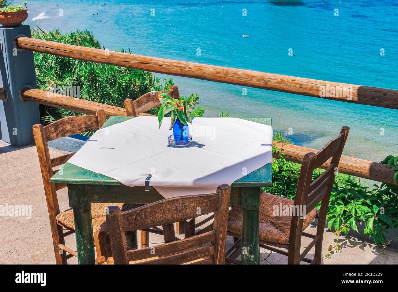 Empty tavern restaurant with wooden chairs and a table by a calm ...