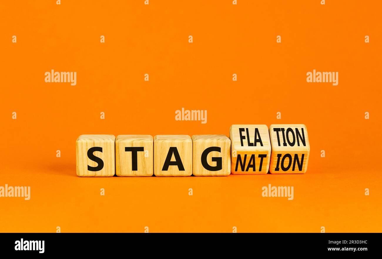 Stagflation or stagnation symbol. Businessman turns cubes, changes the ...