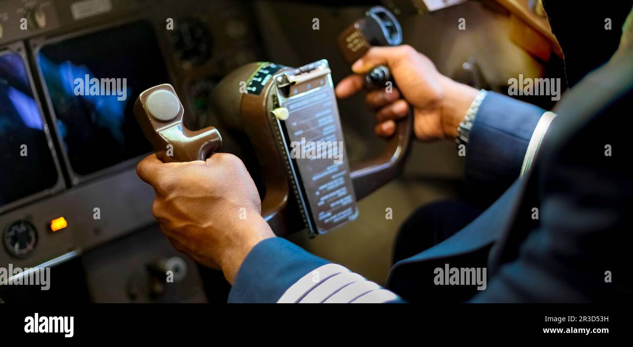 Cropped Hands of African Pilot flying a commercial airplane Stock Photo ...