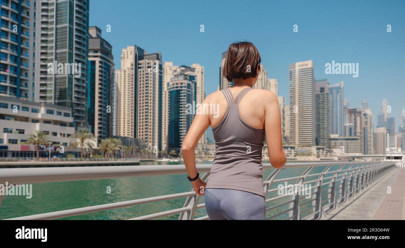 City Running - asian woman runner , Dubai marina urban scene in ...