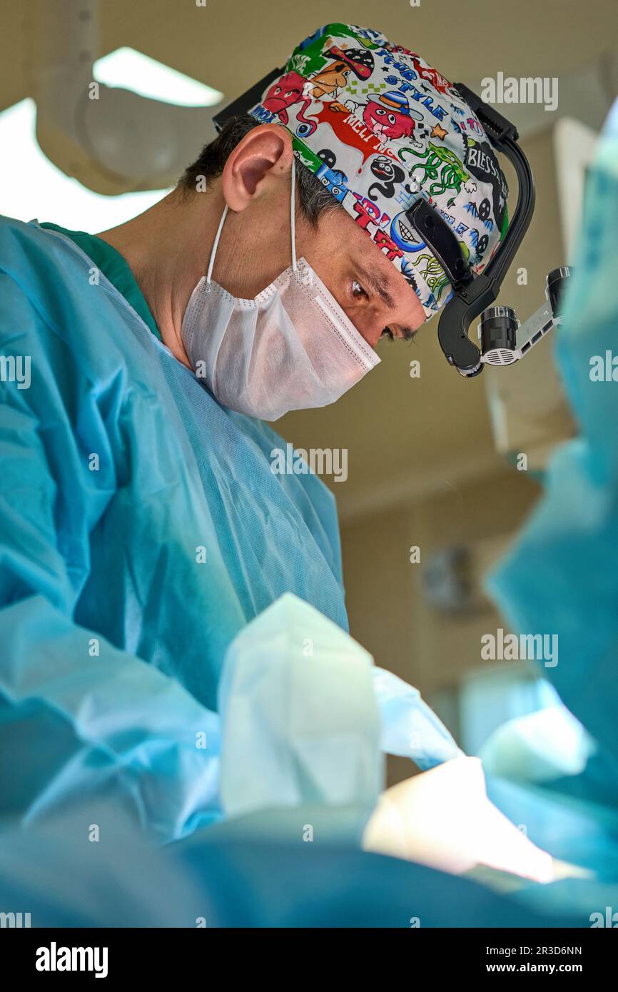 surgeon works in the operating room by the light of a lamp Stock Photo ...