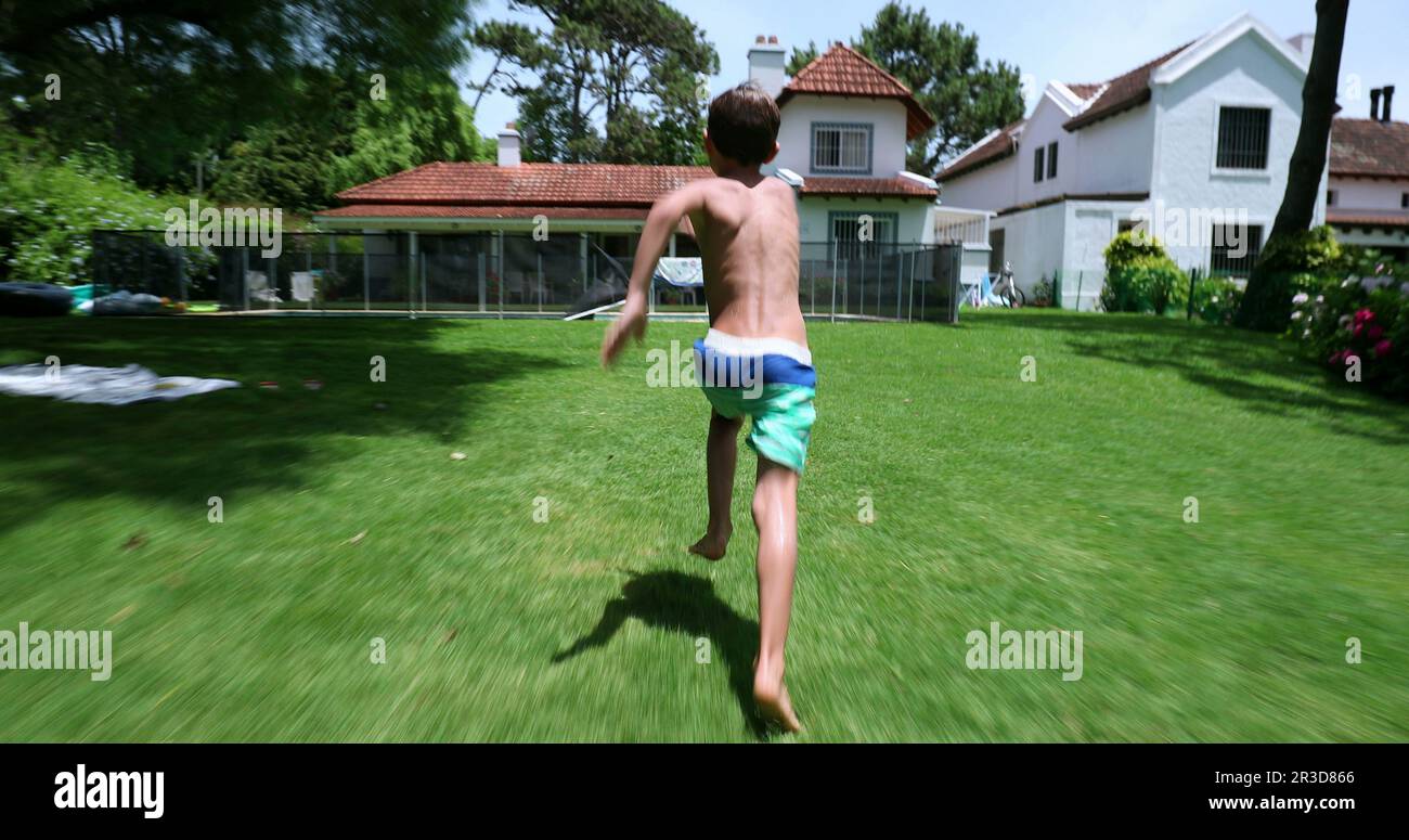 Child sprinting outdoors running and diving into pool water Stock Photo ...