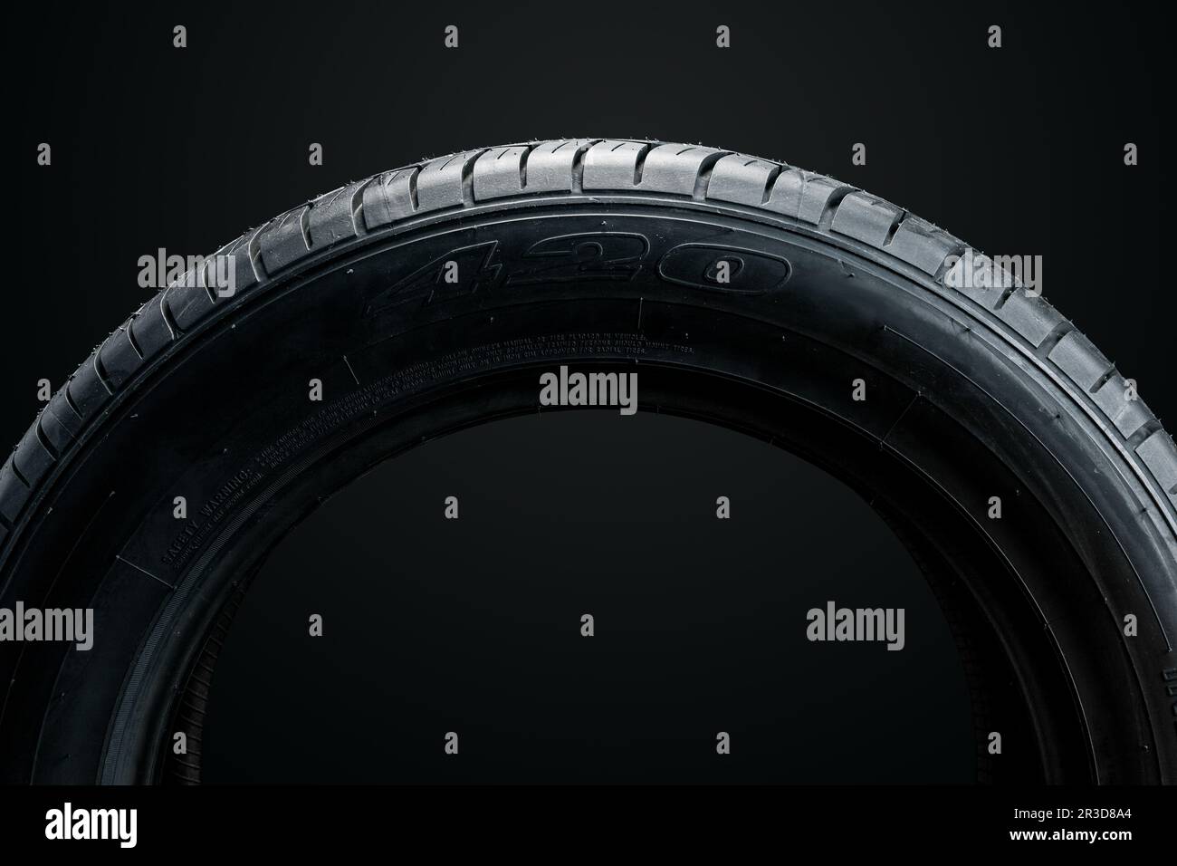 Brand new modern car tyre on a black background. Studio shot Stock ...