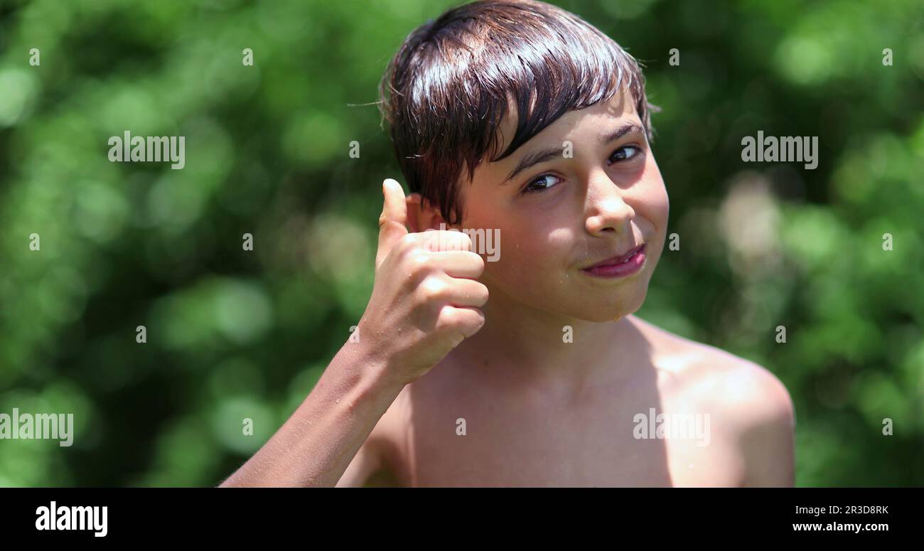 Child giving thumbs up outside boy Stock Photo - Alamy