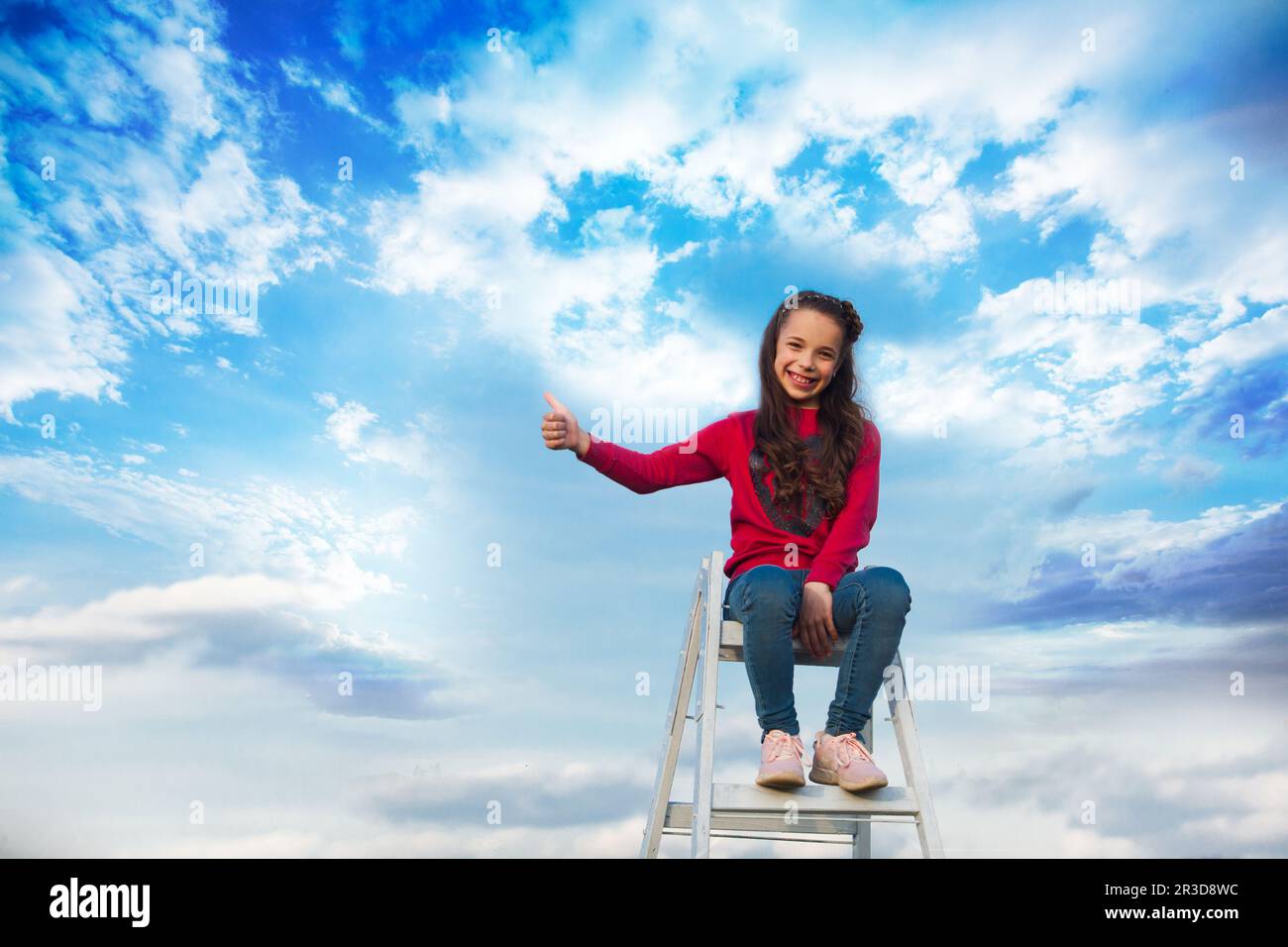 The girl on top of ladder that goes to the sky Stock Photo - Alamy