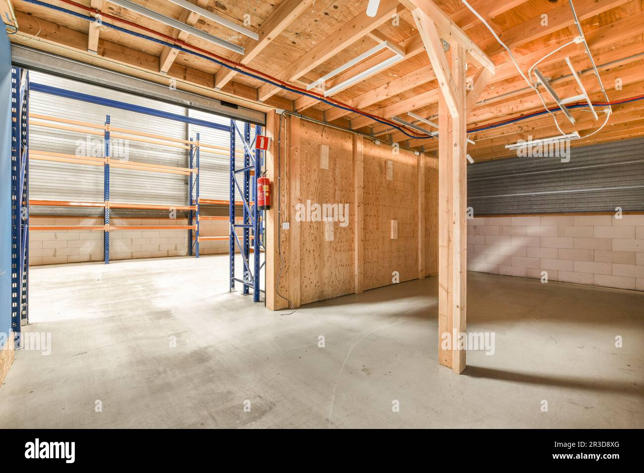 the inside of a building with wood walls and metal ladders hanging on ...